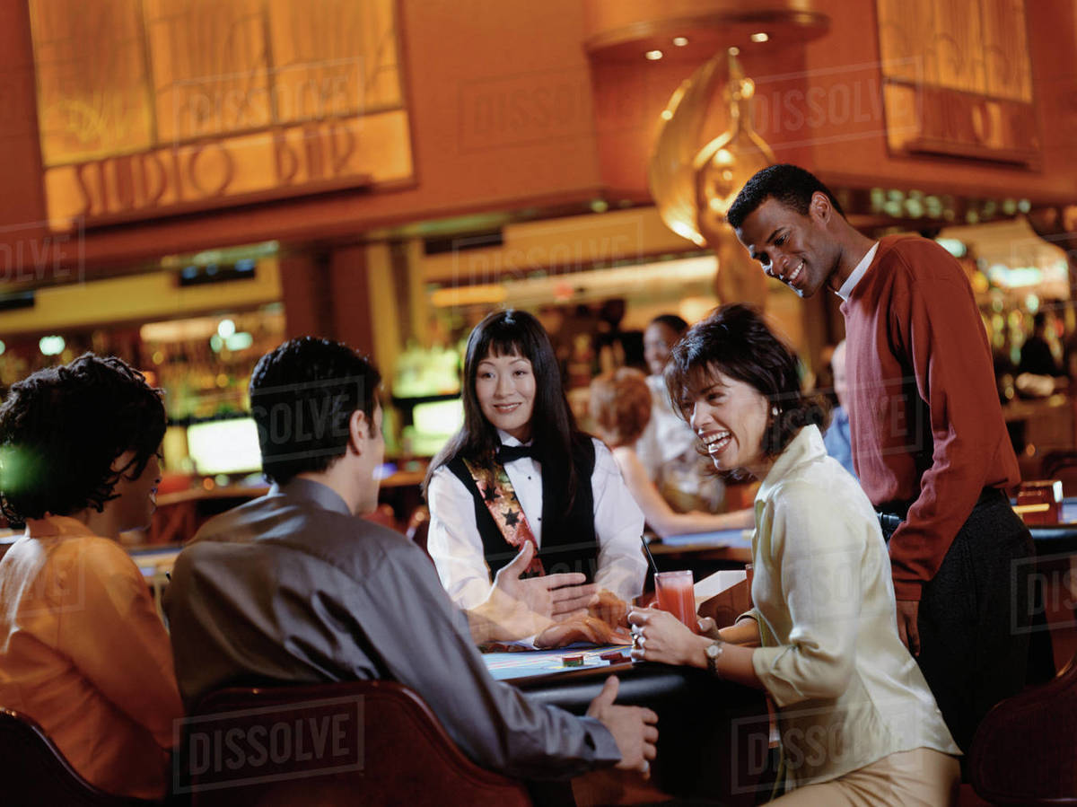 Multi-ethnic group of people at casino - Stock Photo - Dissolve