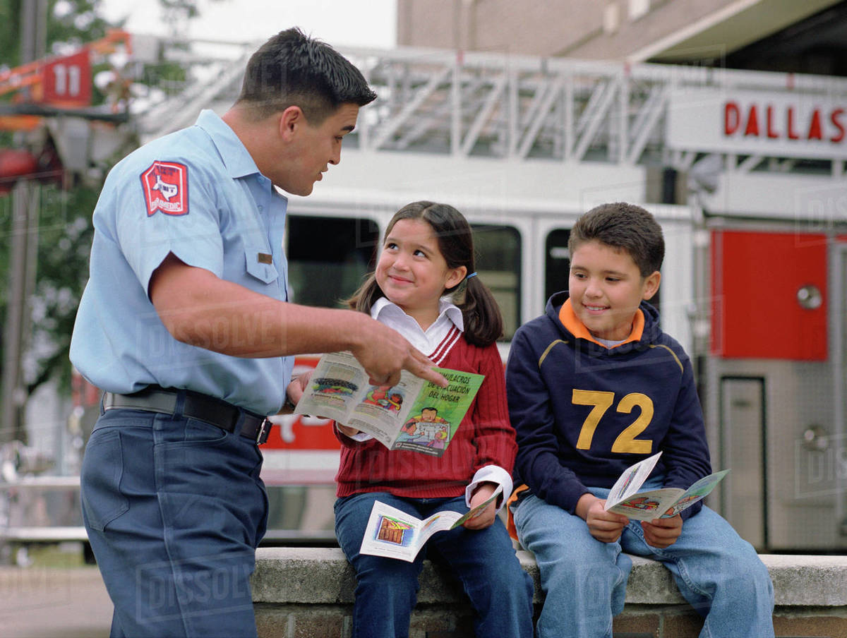 Fireman talking to young children about fire safety - Royalty-free ...