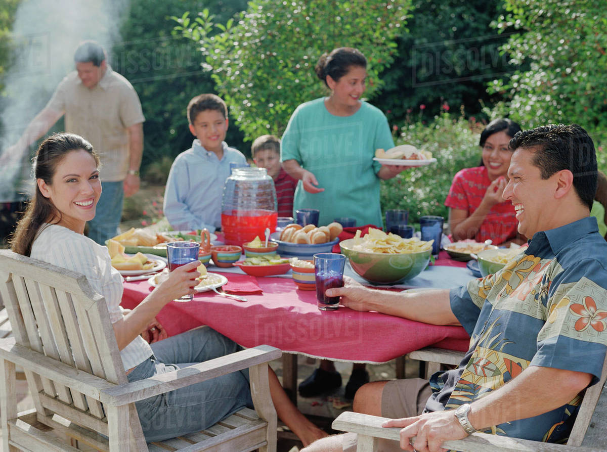 Family eating at a barbecue - Royalty-free Stock Photo | Dissolve