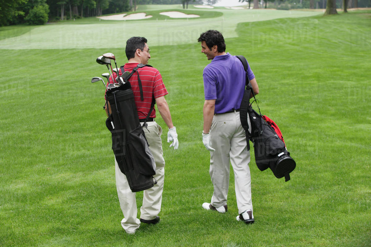 Rear view of two men playing golf - Royalty-free Stock Photo | Dissolve