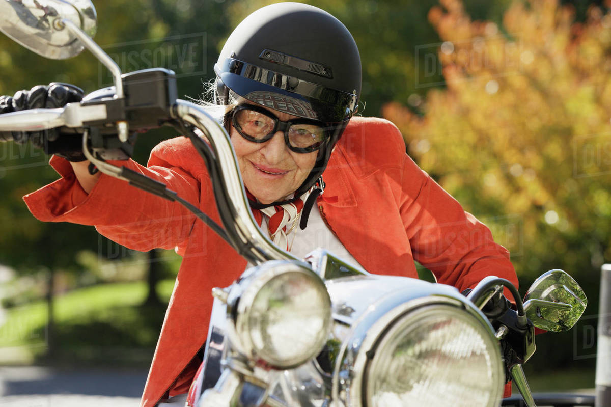Elderly woman driving a motorcycle - Royalty-free Stock Photo | Dissolve
