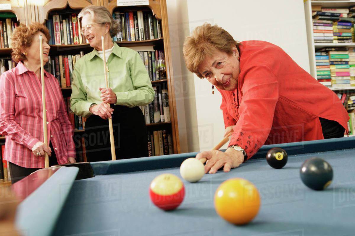 Elderly woman shooting pool - Royalty-free Stock Photo | Dissolve