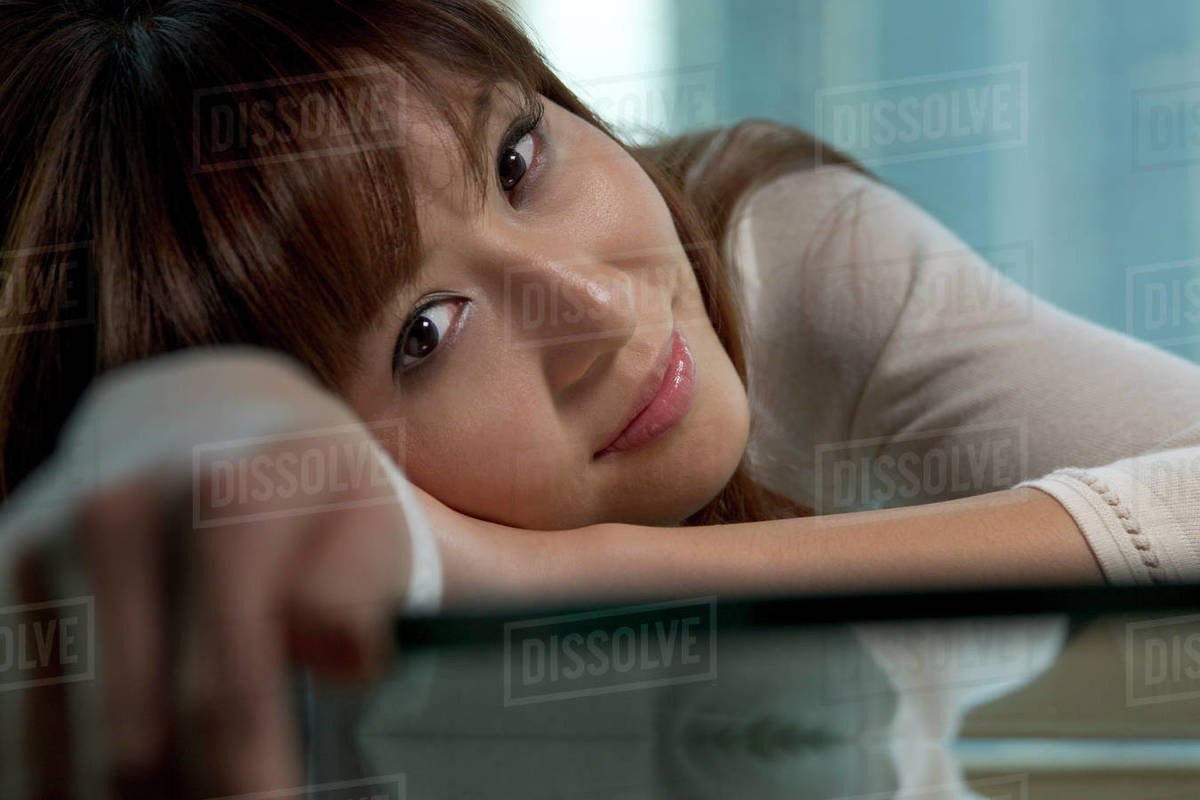 Woman leaning on table - Royalty-free Stock Photo | Dissolve