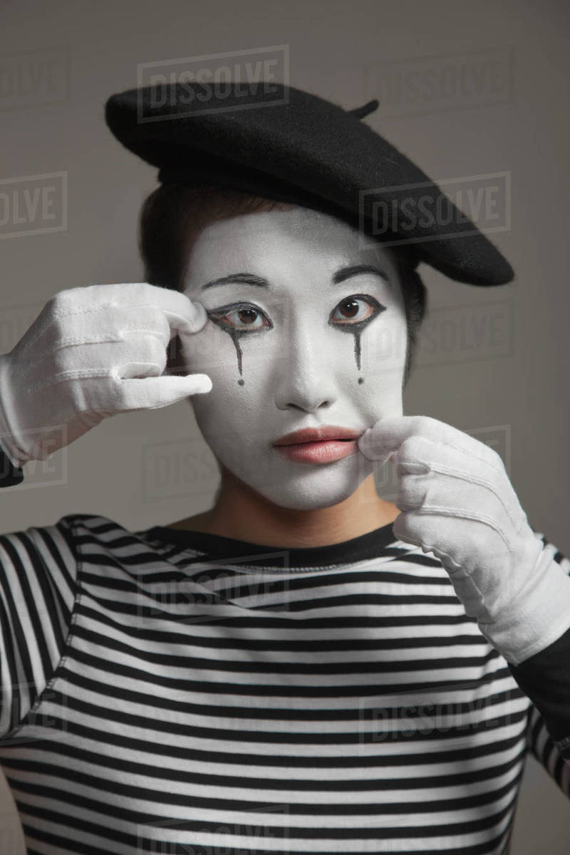 Woman in mime costume stretching her face - Royalty-free Stock Photo ...