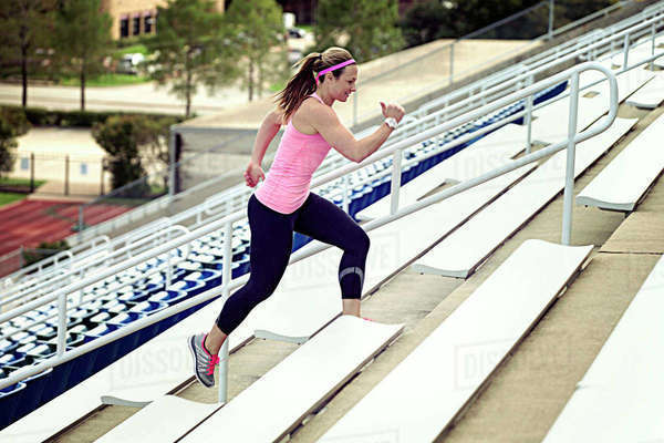 Caucasian athlete running up bleachers - Royalty-free Stock Photo ...