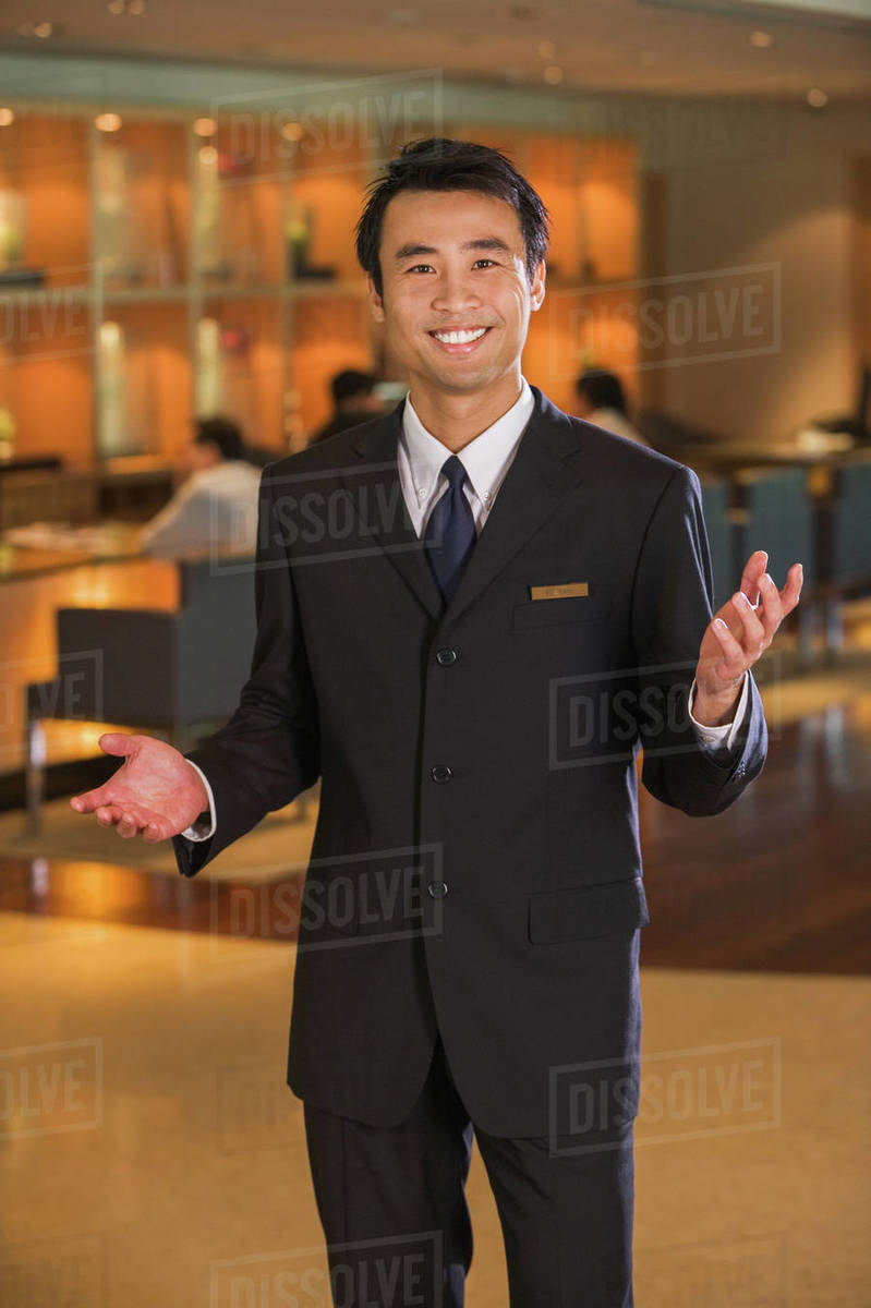 Chinese businessman welcoming guests to bar - Royalty-free Stock Photo ...