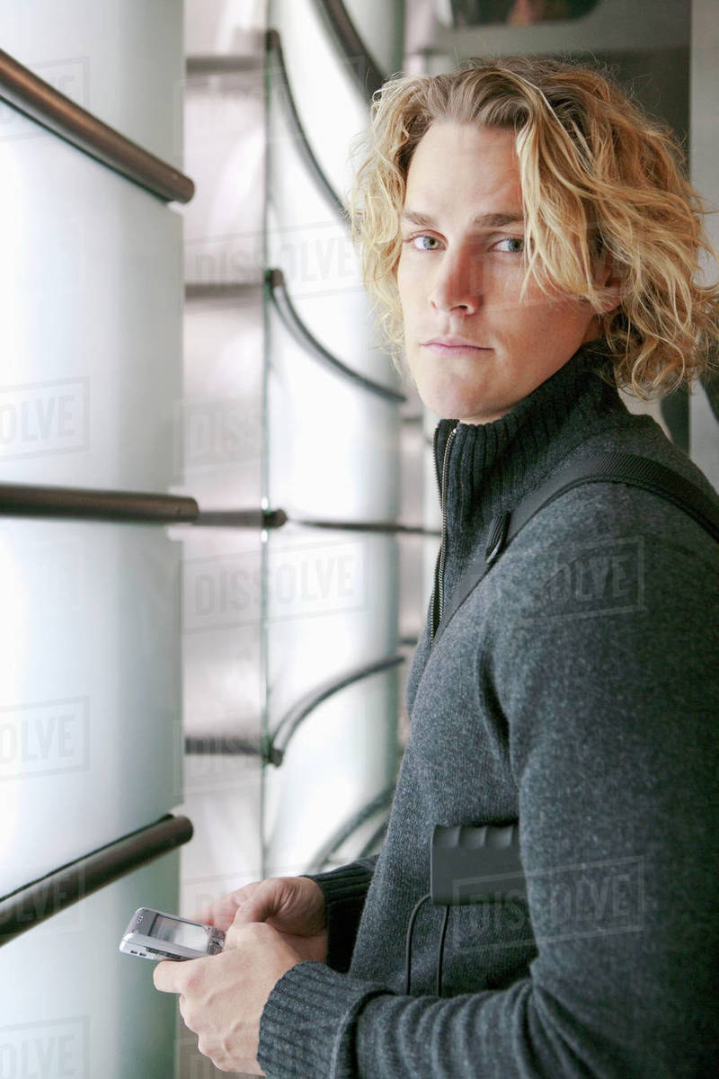 Serious Caucasian man holding cell phone - Royalty-free Stock Photo ...