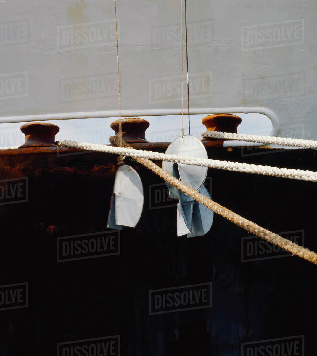 Ropes securing ship to mooring bollards on the wharf - Royalty-free ...