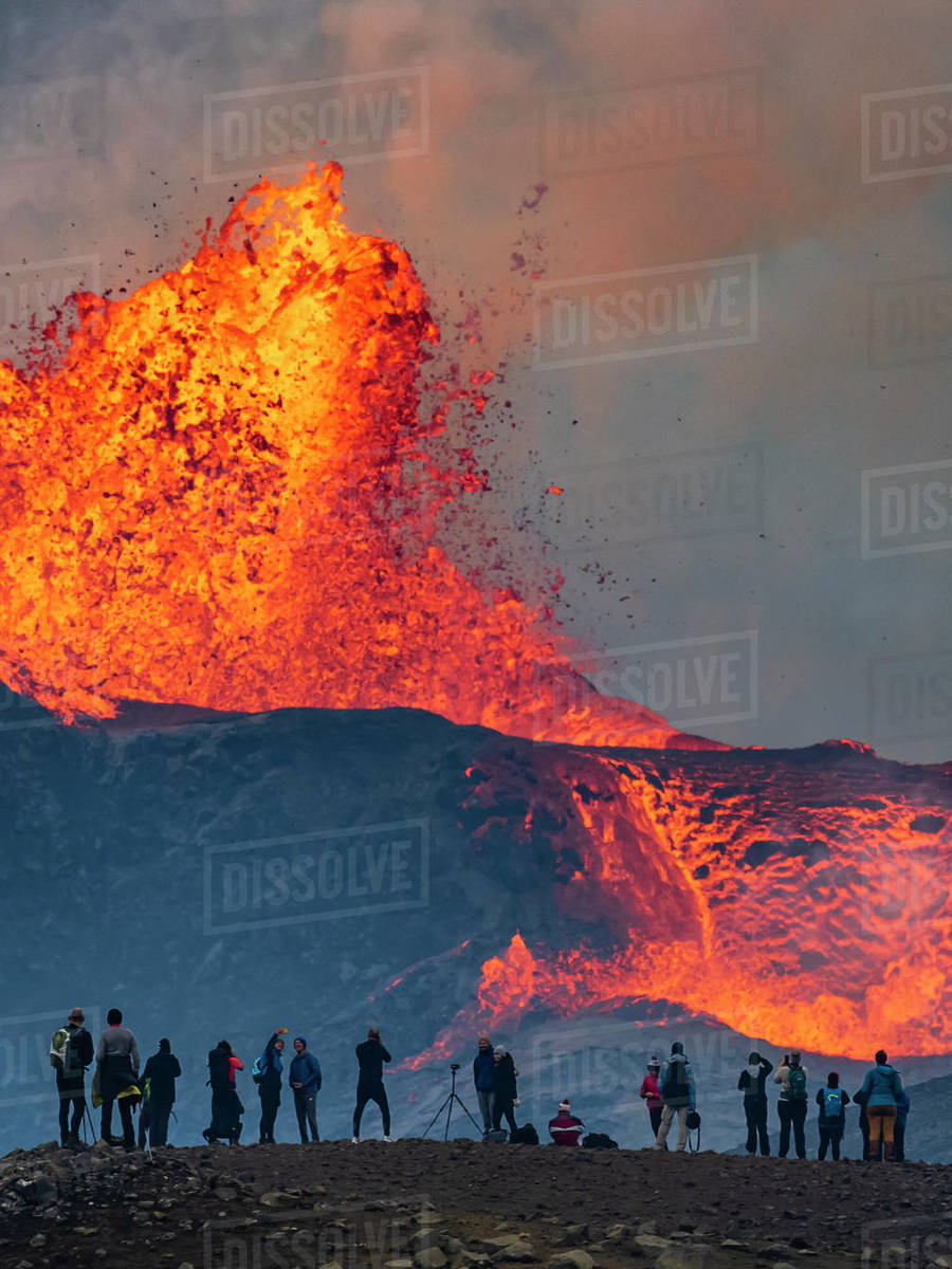 Hikers enjoy fireworks from Observation Hill as glowing lava is ejected ...