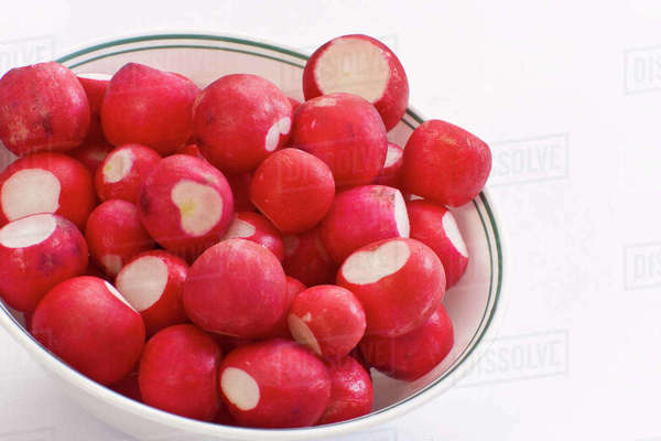 Cleaned Fresh radishes in bowl on white background - Stock Photo - Dissolve