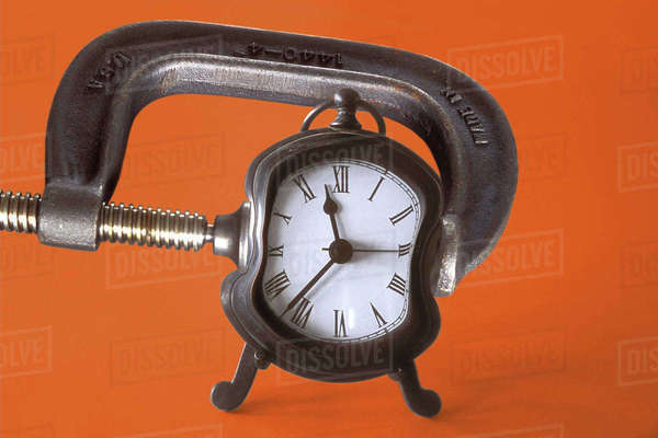 Close-up of an clamp squeezing an alarm clock - Royalty-free Stock ...