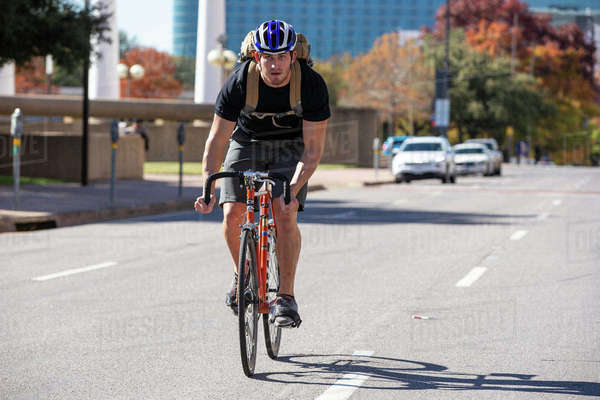 Happy man riding bicycle on sunny city street - Royalty-free Stock ...
