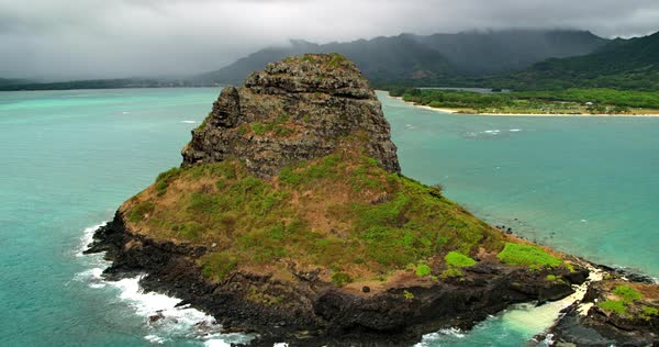 Interior view of helicopter flying around desolate island in middle of ...
