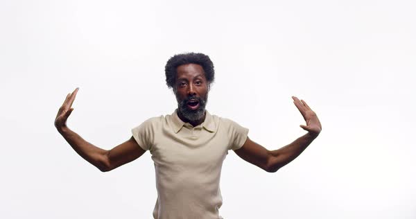 A man pushes his arms out and shakes his head and shoulders - 4K ...