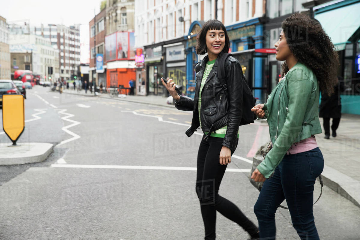 Two women walking and talking on the streets of London - Royalty-free ...