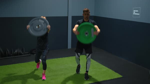 A young couple trains in the gym doing modern exercises to improve ...