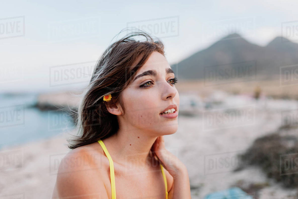 Woman in the beach wearing yellow swimsuit - Stock Photo - Dissolve