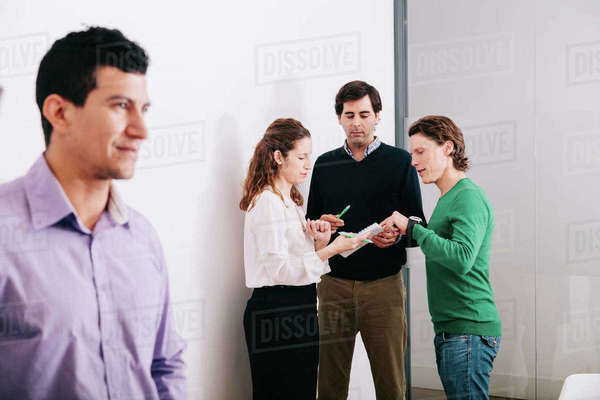 Group of office workers at a meeting standing around the boss - Royalty ...