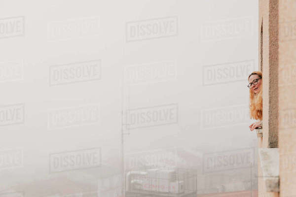 Quarantined woman bending over the window watching outside - Stock ...