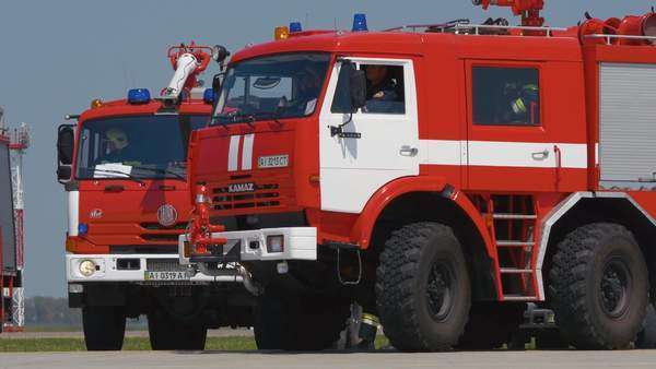 KIEV - MAY 22, 2015: Panning shot of big fire truck arriving at airport ...