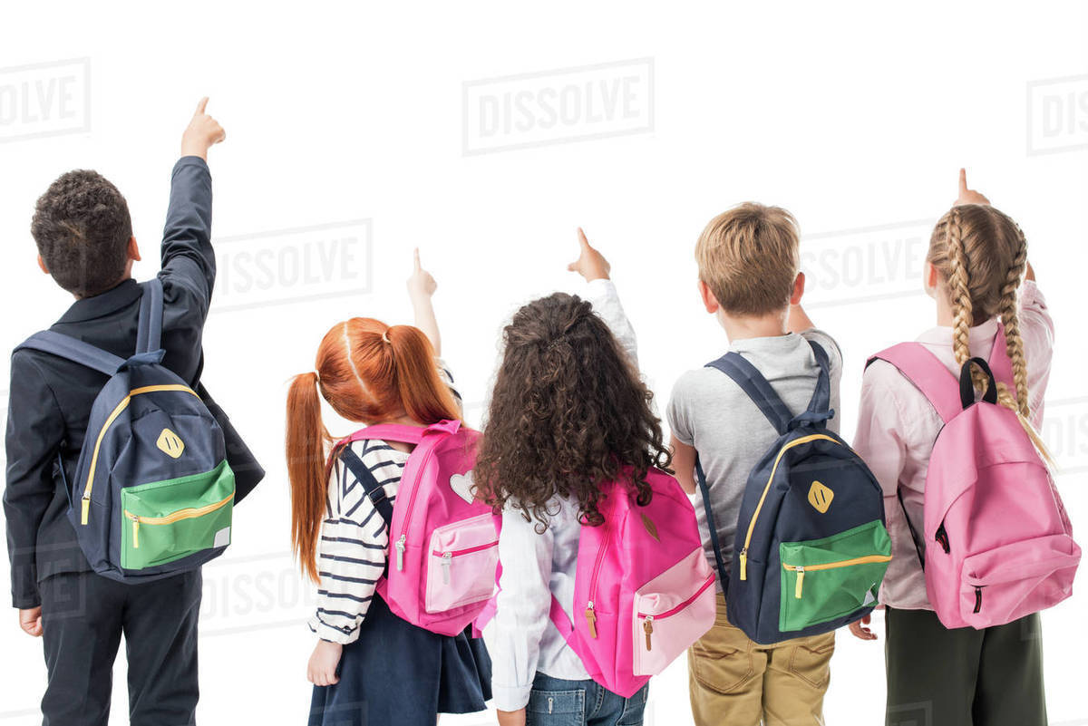 Back view of multiethnic children with backpacks pointing at copy space ...