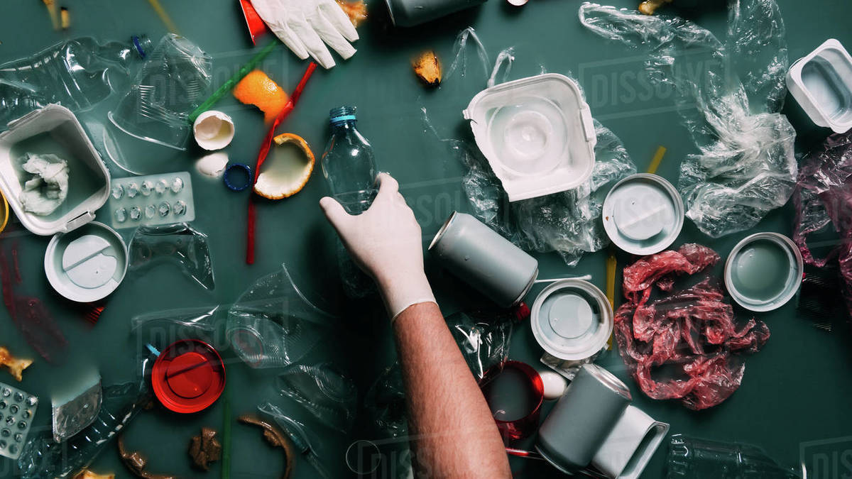 Partial view of man in latex glove cleaning water from trash, ecology ...