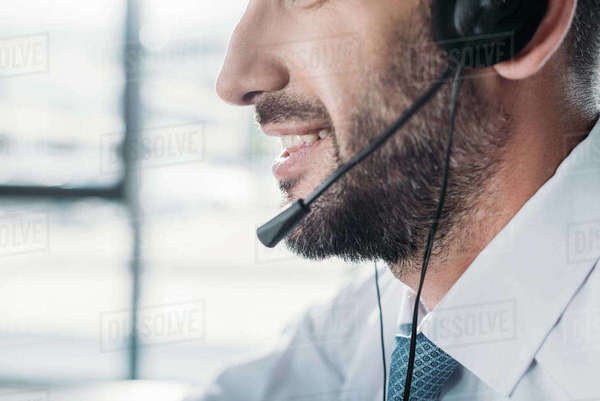 Cropped shot of happy support hotline worker in white shirt at work ...