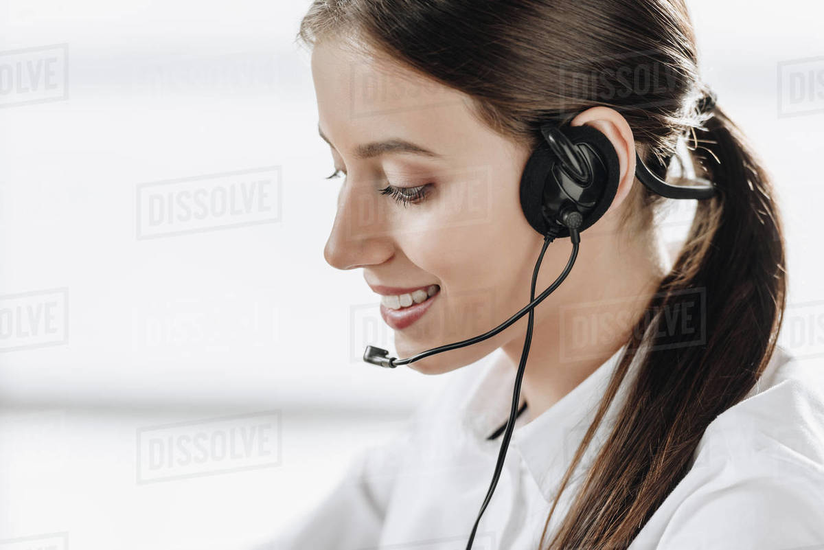 Beautiful female call center worker with headphones - Royalty-free ...