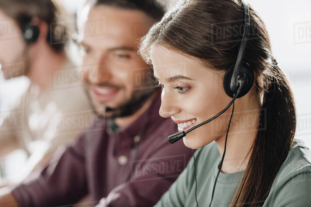 Happy team of call center managers working together at modern office ...