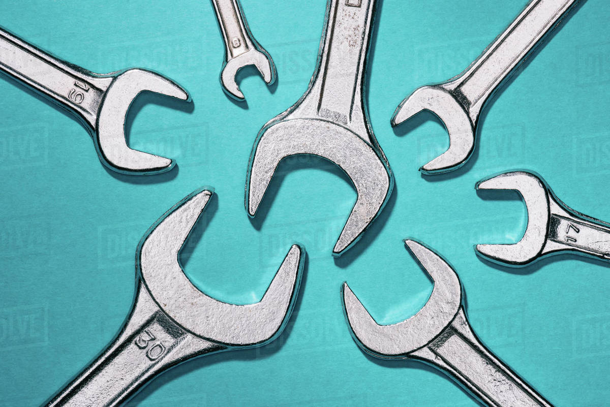Top view of different sized wrenches isolated on blue - Stock Photo ...