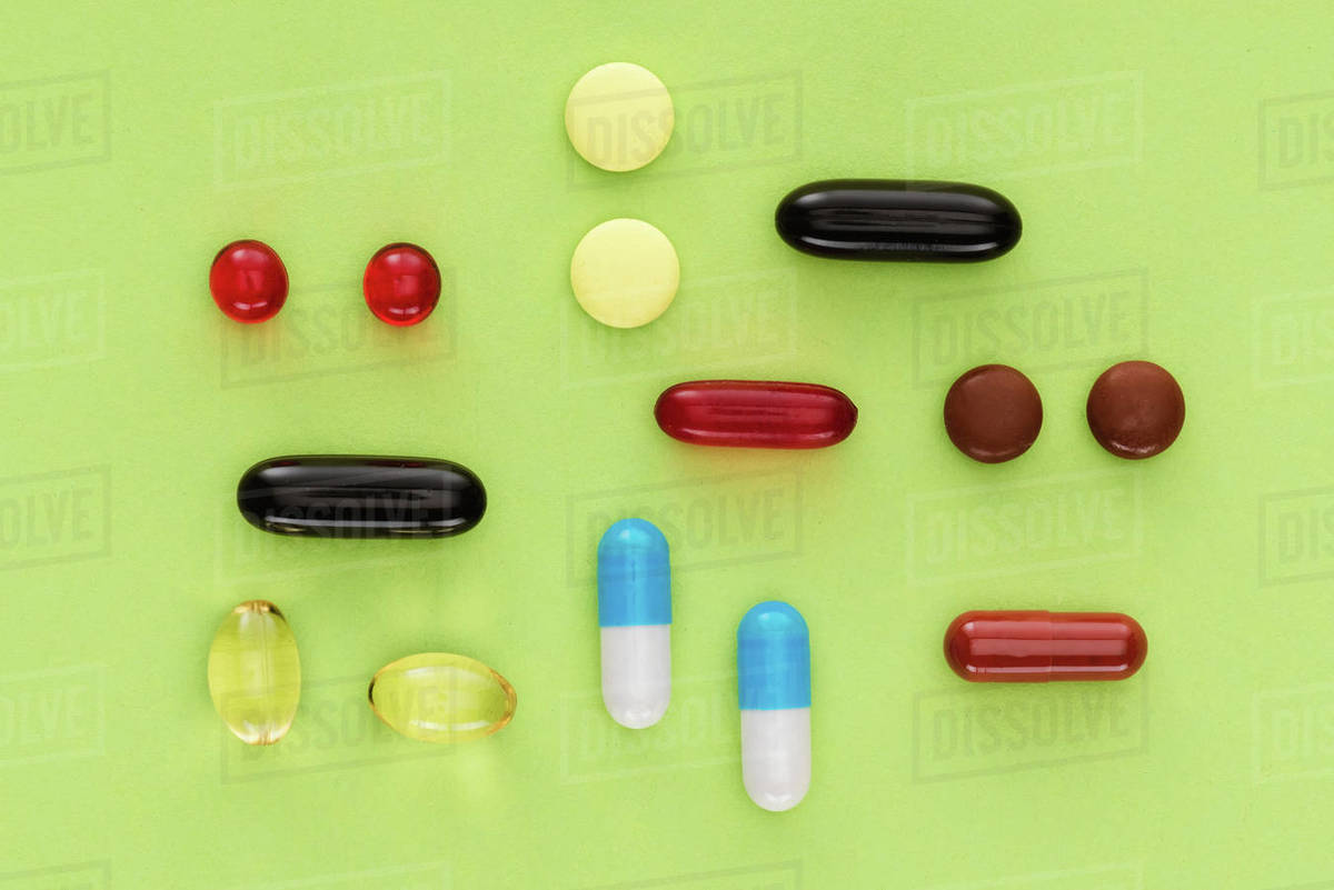 top view of arranged various pills on green background - Stock Photo ...
