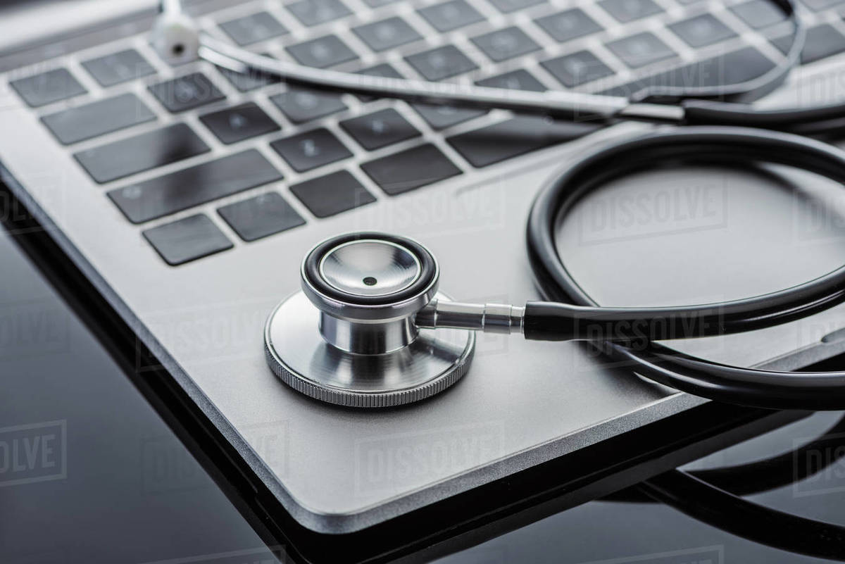 selective focus of stethoscope and laptop on glass surface - Royalty ...