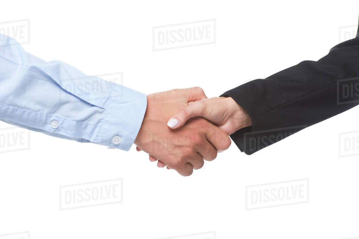 Cropped shot of business partners shaking hands isolated on white ...