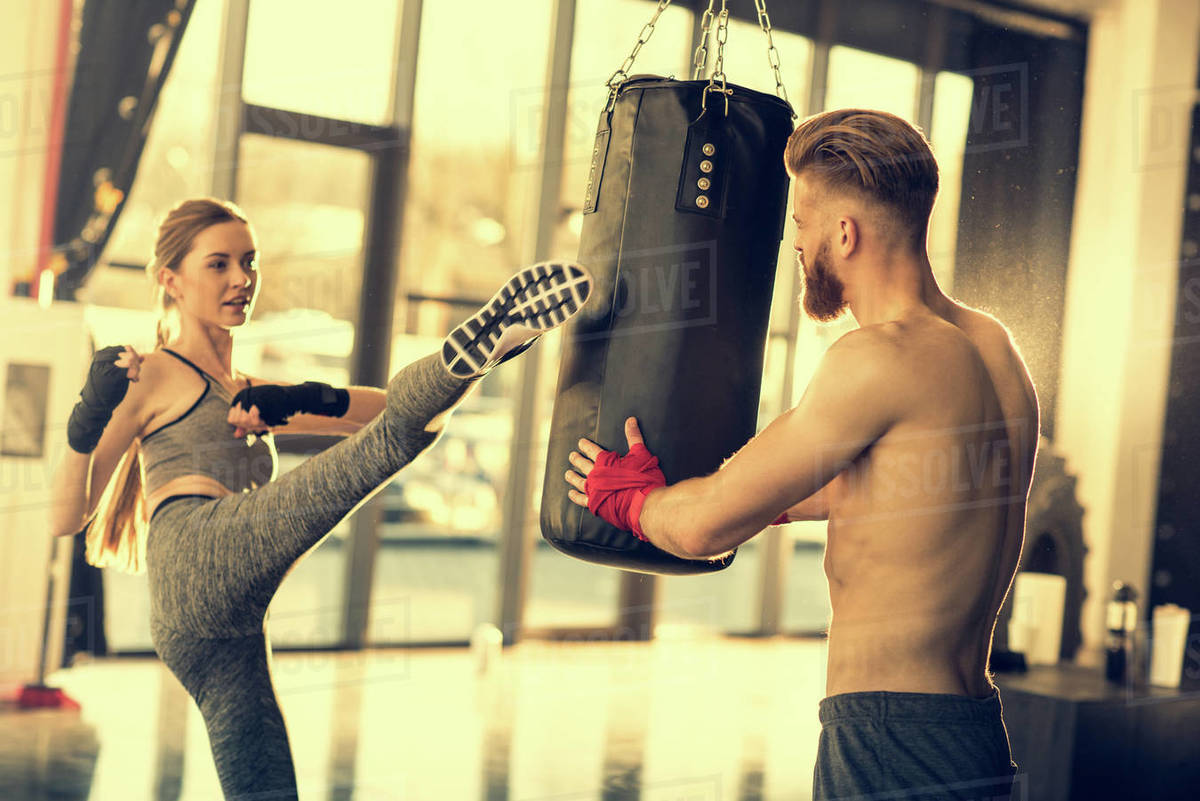 Young sporty man and woman exercising - Stock Photo - Dissolve