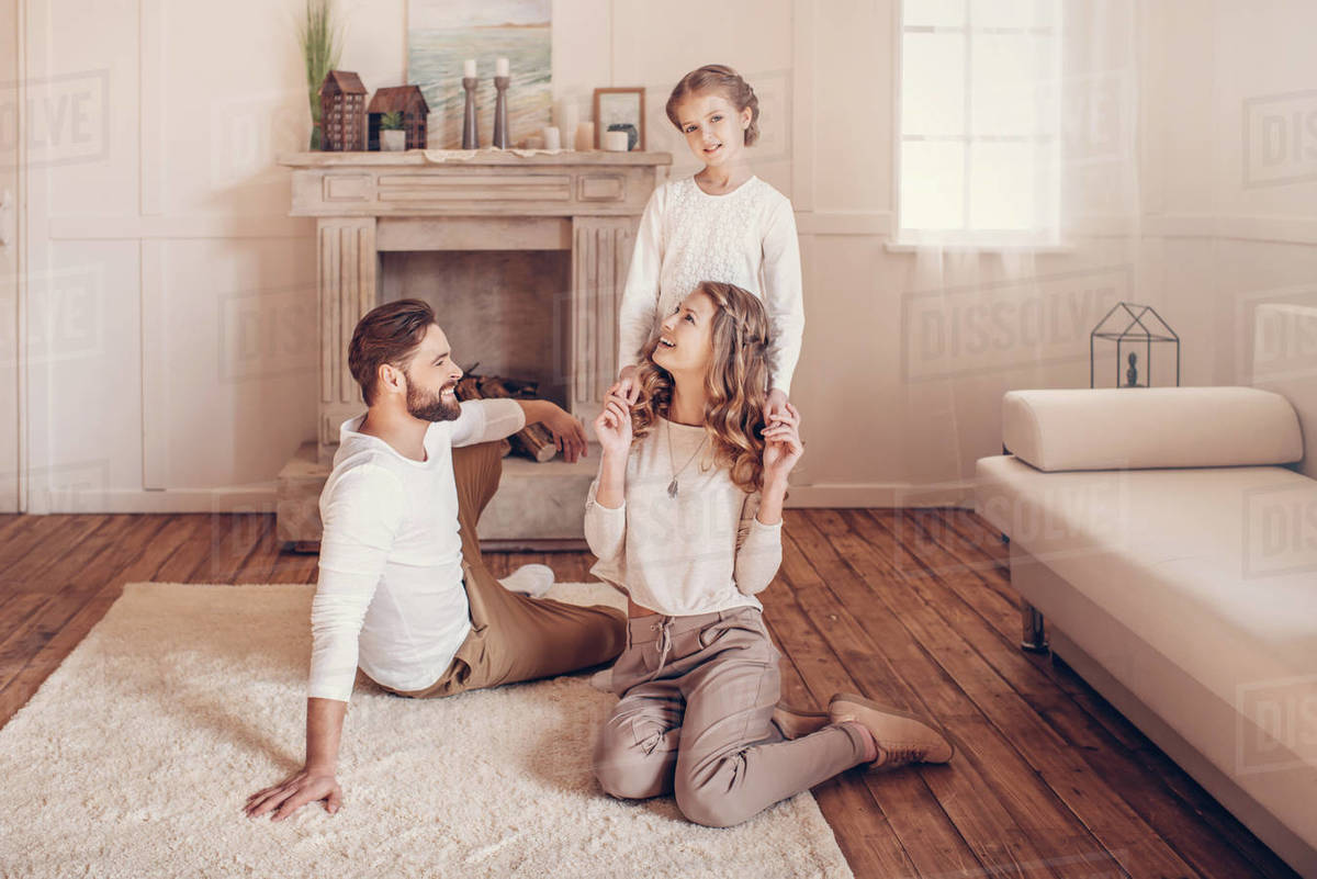 Happy young family with one child spending time together at home ...