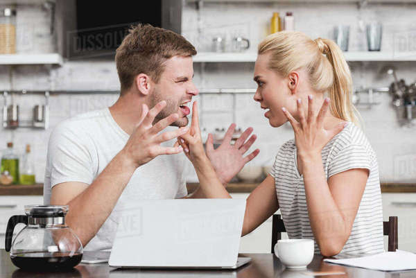 emotional young couple arguing and looking at each other, relationship ...