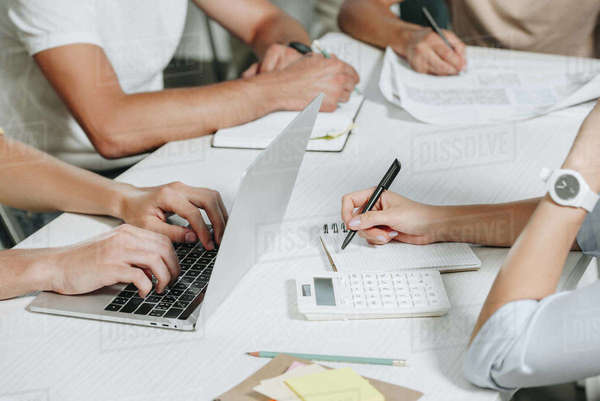 cropped image of businesspeople working at table in office - Stock ...