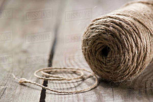 Selective focus of beige string on wooden background - Stock Photo ...