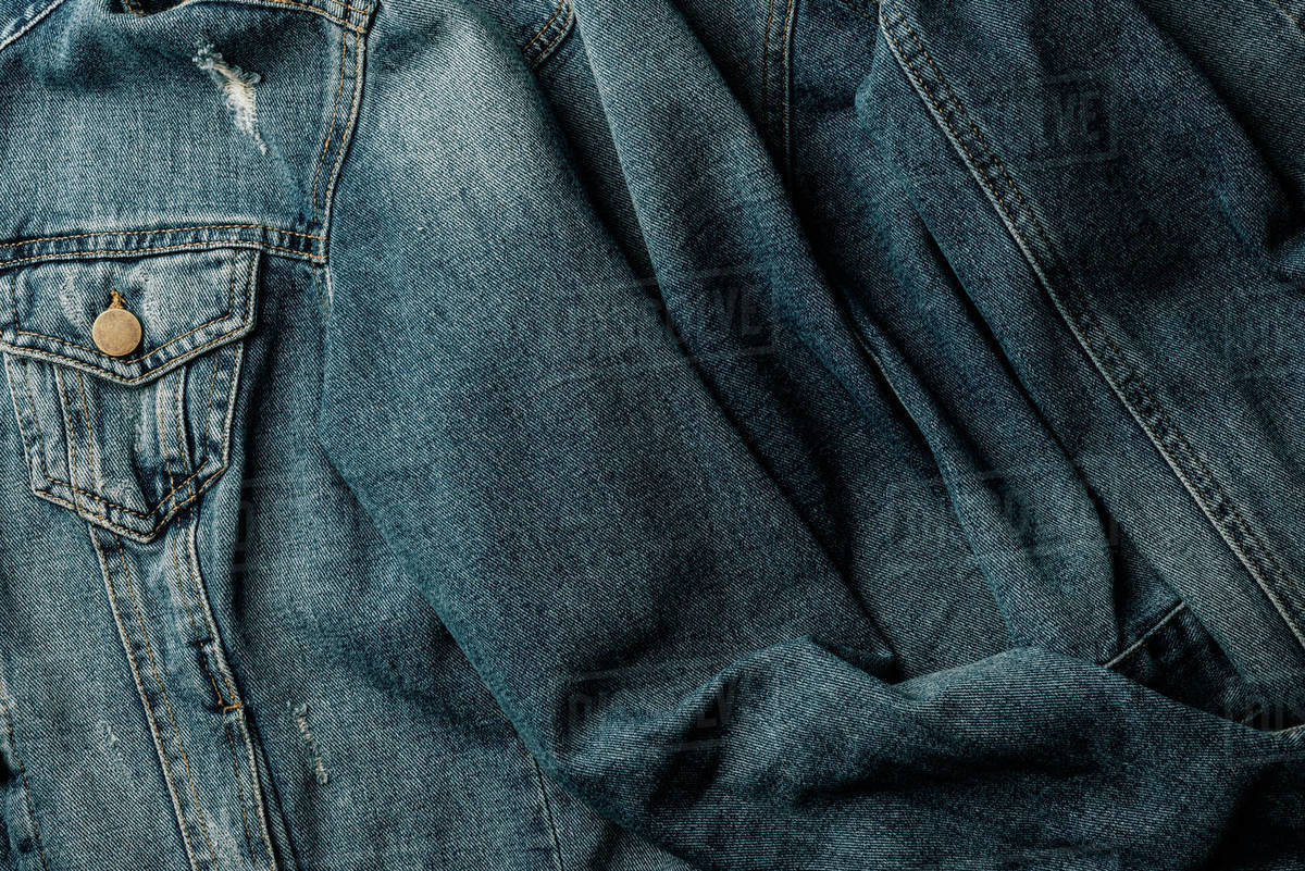 Top view of denim jacket as background - Stock Photo - Dissolve