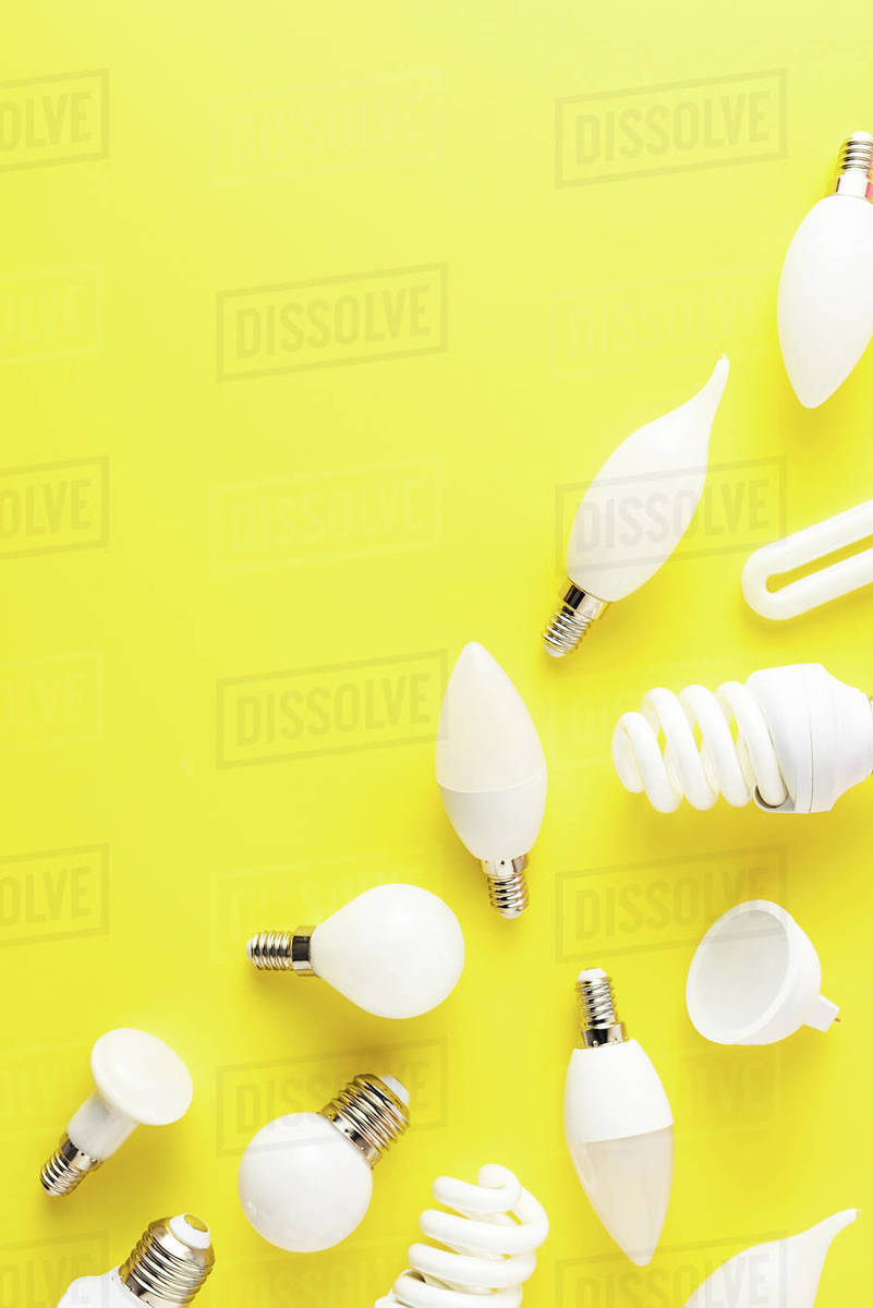 Top view of various types of light bulbs on yellow background - Royalty ...