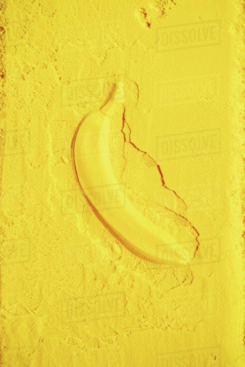 Top view of banana shape in bright yellow powder - Royalty-free Stock ...