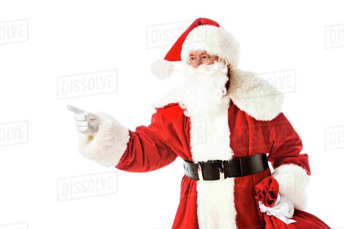 Santa claus pointing on side while looking at camera isolated on white ...