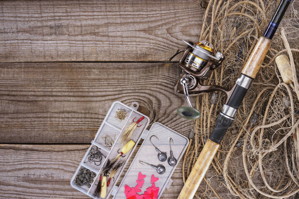 Flat lay with fishing net, fishing rod and plastic box with fishing ...