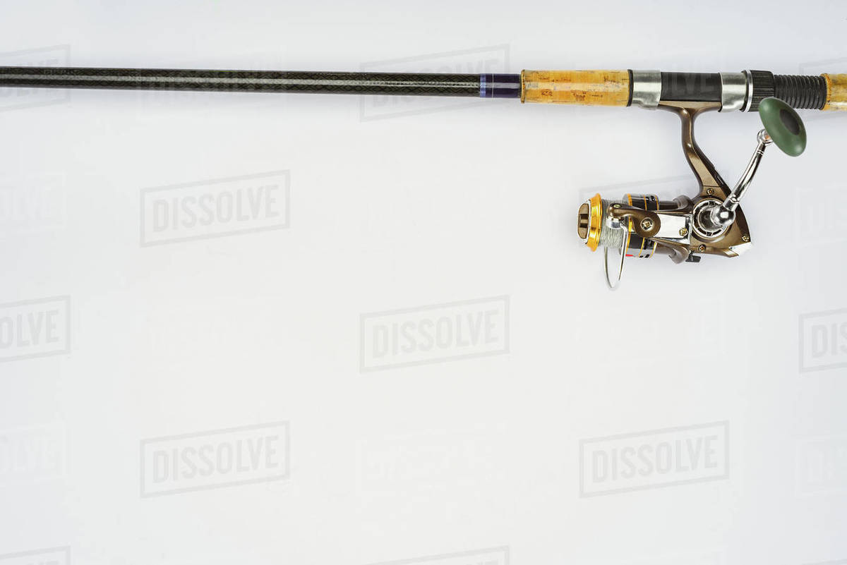 Elevated view of fishing rod isolated on white, minimalistic concept ...
