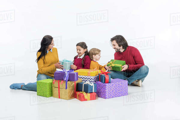 Happy parents and kids with wrapped gift boxes isolated on white ...