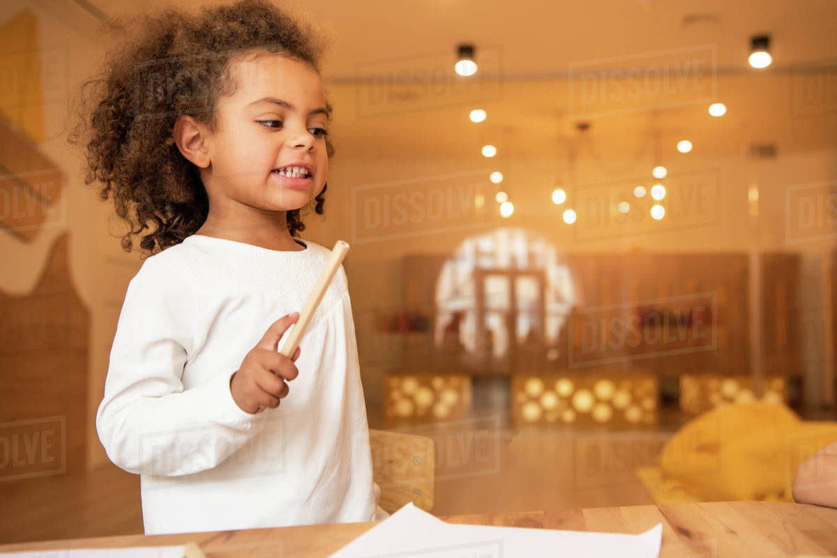 African american kid holding felt tip pen in kindergarten - Royalty ...