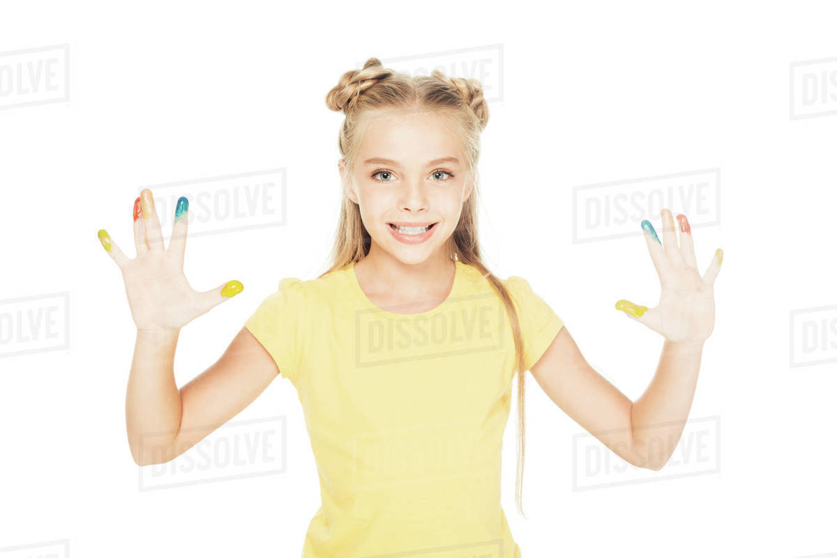 Adorable child showing colorful painted hands and smiling at camera ...