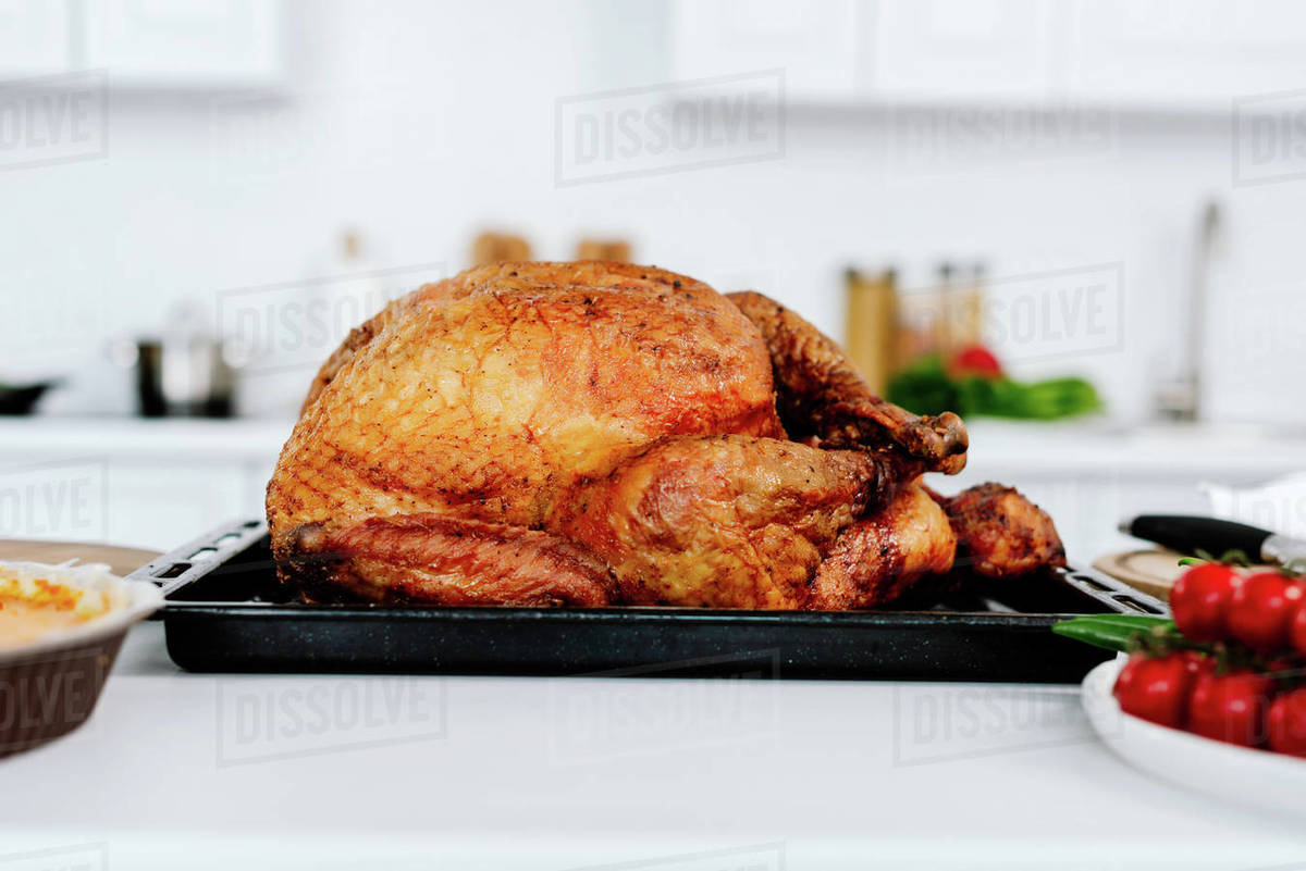 Close-up shot of freshly baked turkey on table at kitchen for ...