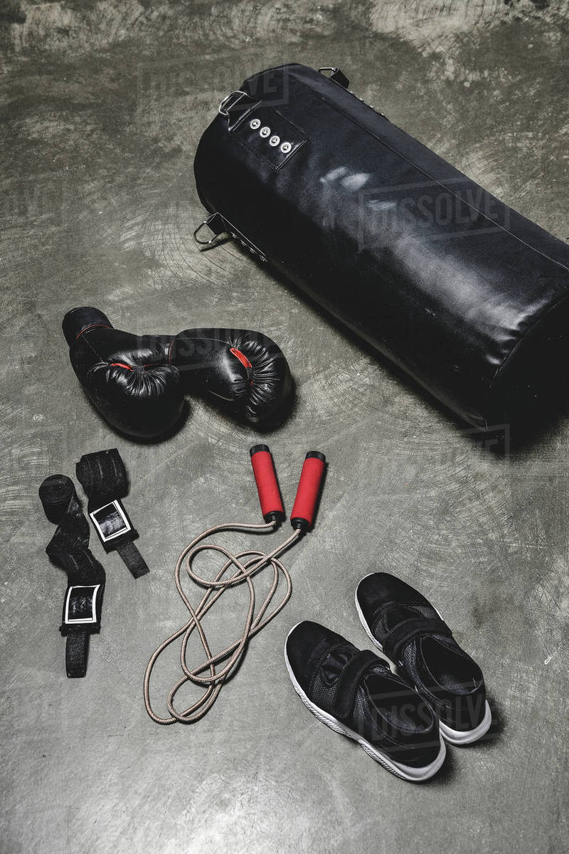 High angle view of various boxing equipment lying on concrete surface ...