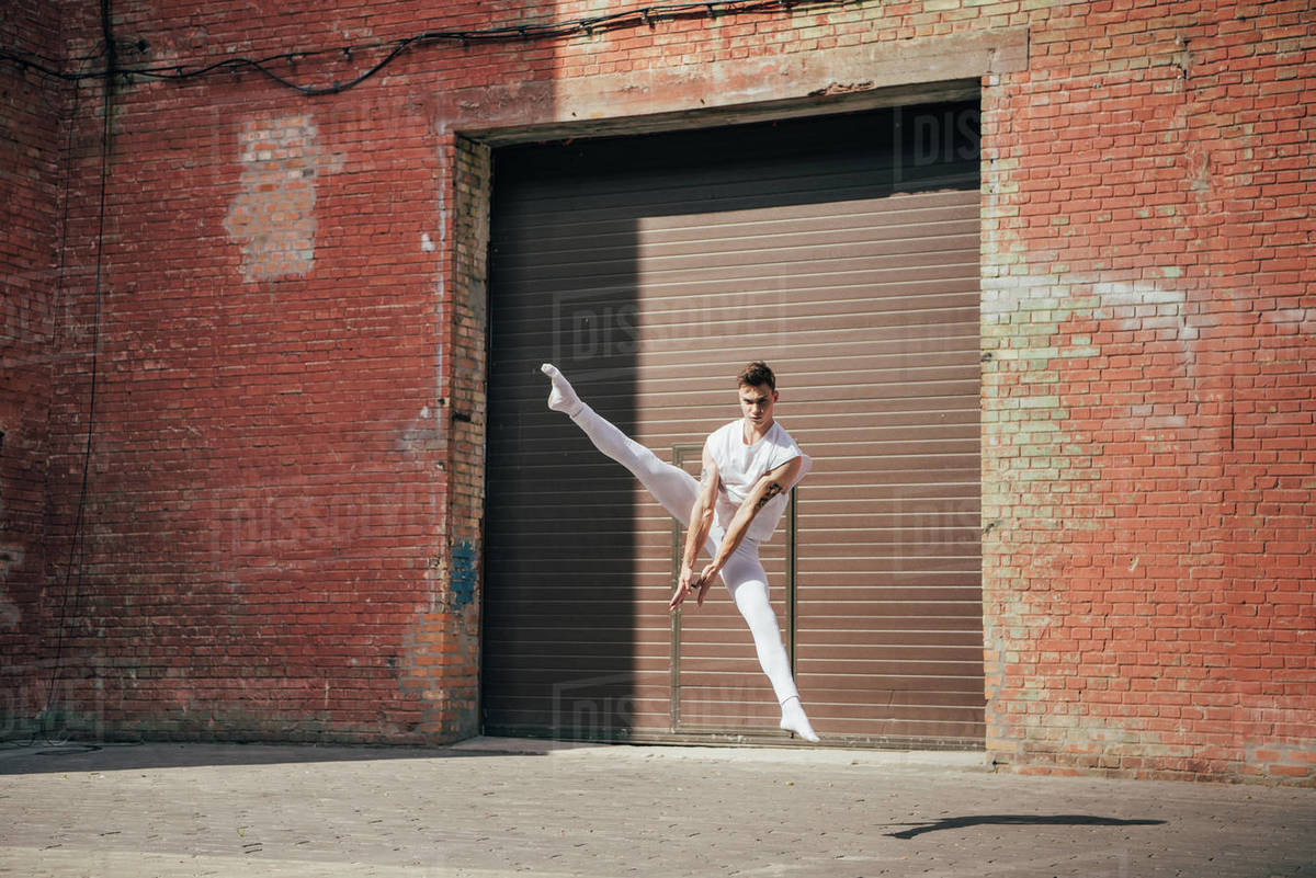 Young ballet dancer dancing in jump on urban street - Stock Photo ...